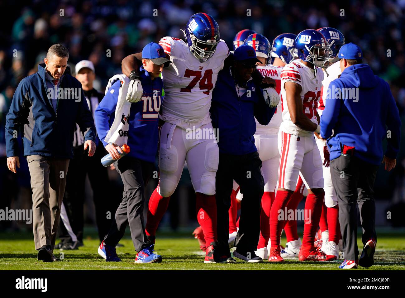 New York Giants' Matt Peart (74) is helped off the field during the ...