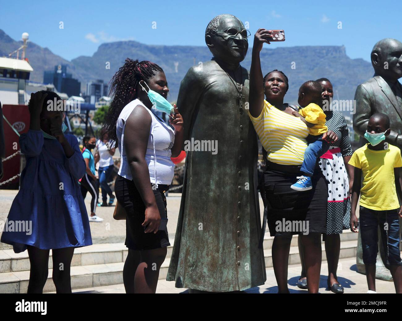People take photos at a statue of Anglican Archbishop Desmond Tutu at ...