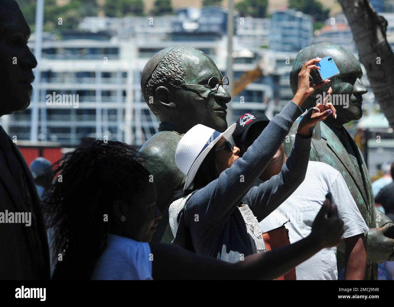 People take photos at a statue of Anglican Archbishop Desmond Tutu at ...
