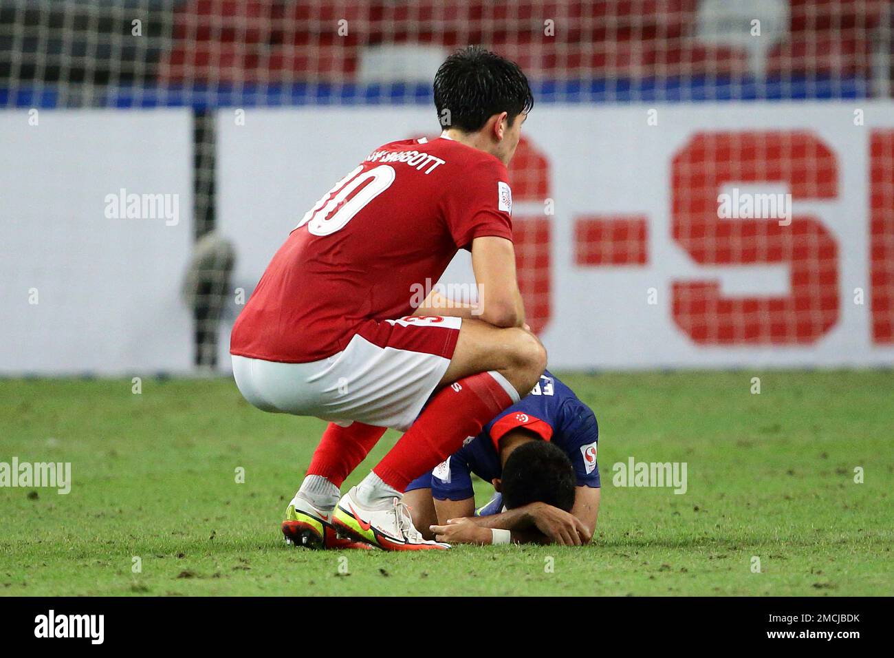 Elkan William Tio Baggott of Indonesia, left, consoles Faris Ramli of ...