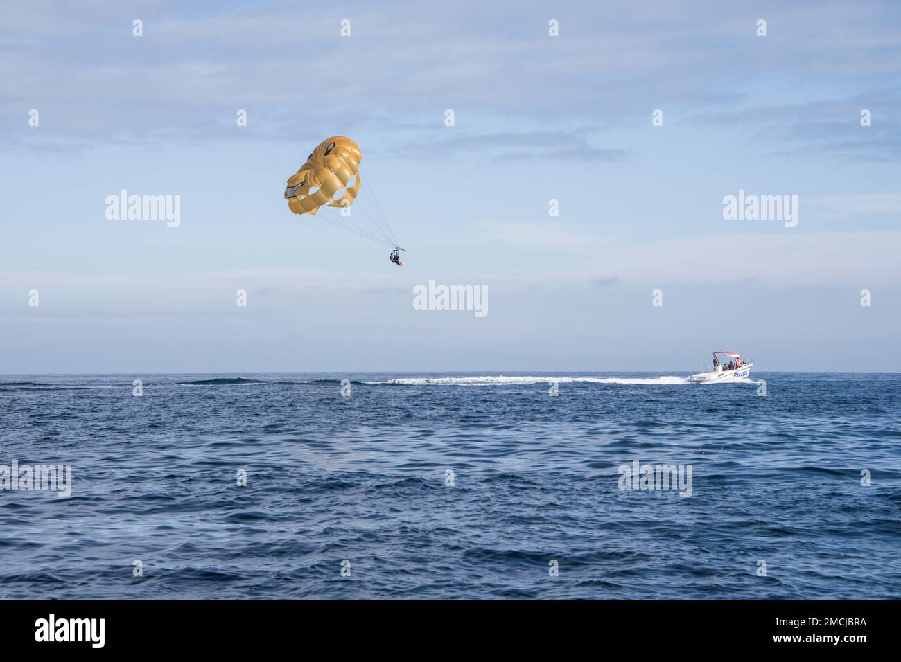 Parasailing, a parachute pulled behind a boat, is a popular sport with ...