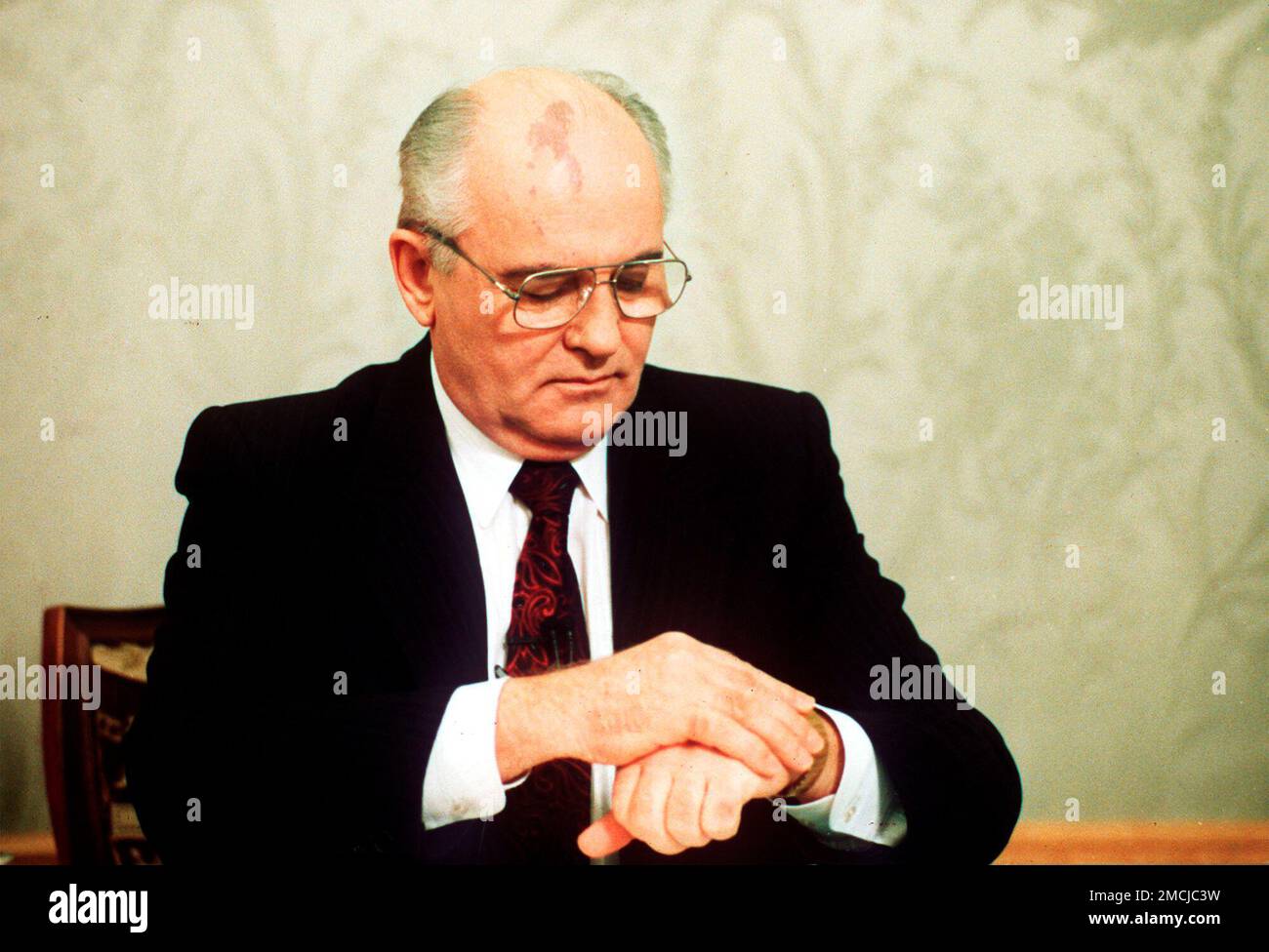 FILE - Soviet President Mikhail Gorbachev checks the time on his watch ...
