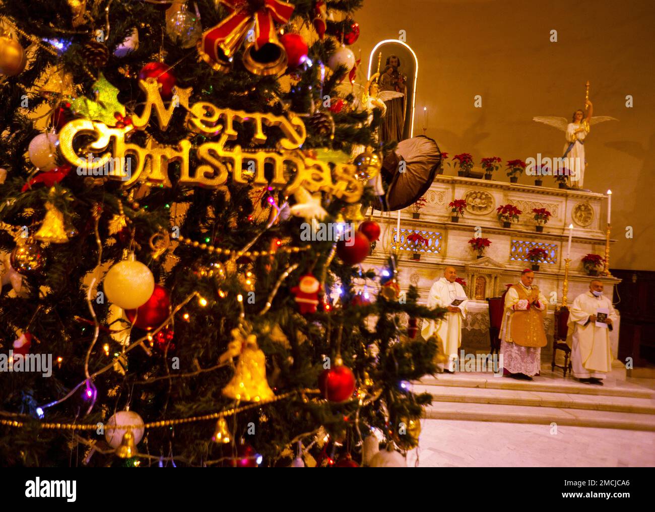 Archbishop Nicolas Henry Thevenin, center, leads the Christmas Eve Mass ...