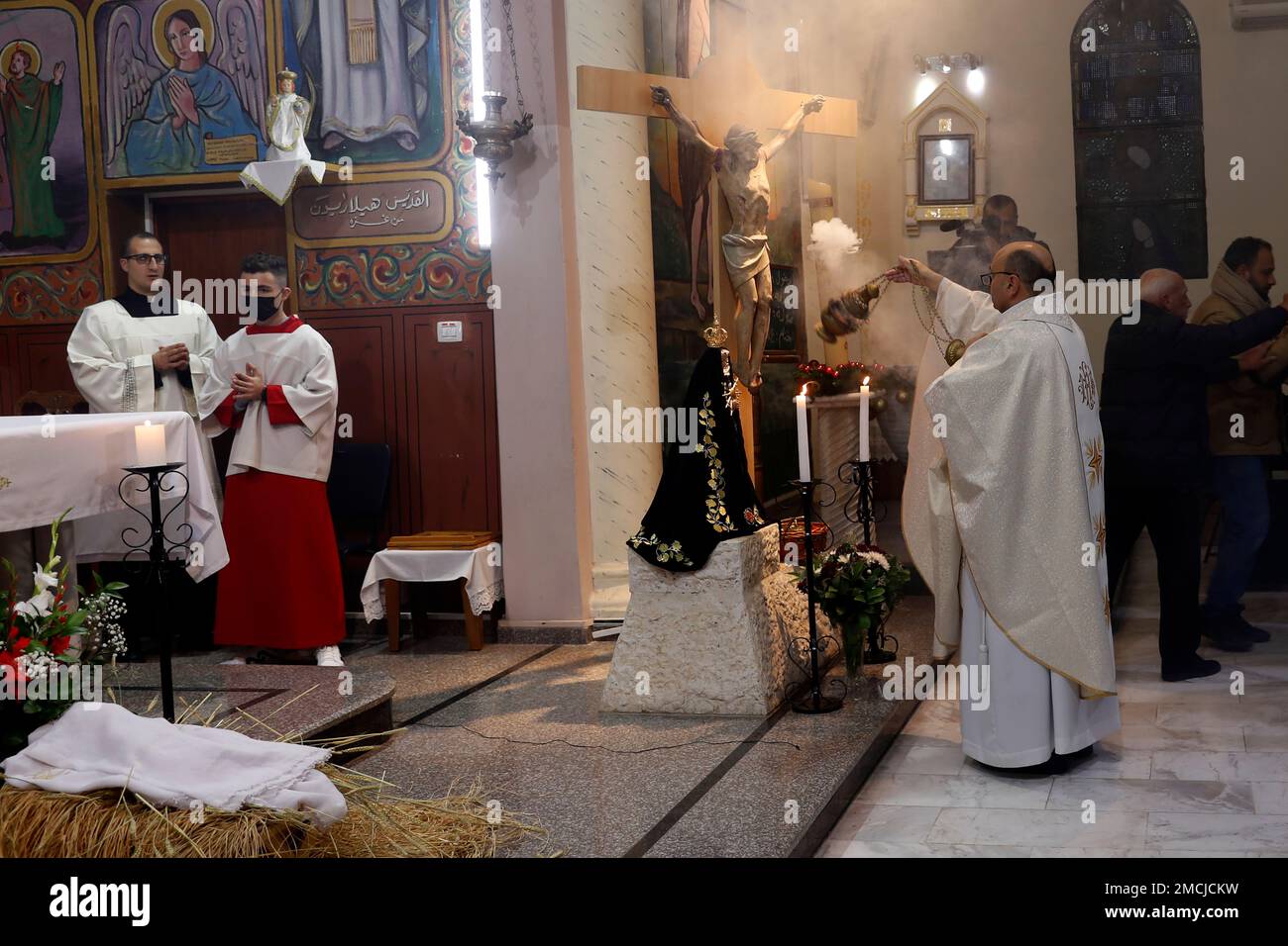 Fr. Gabriel Romanelli, Latin parish priest of Gaza Strip, left, prays ...