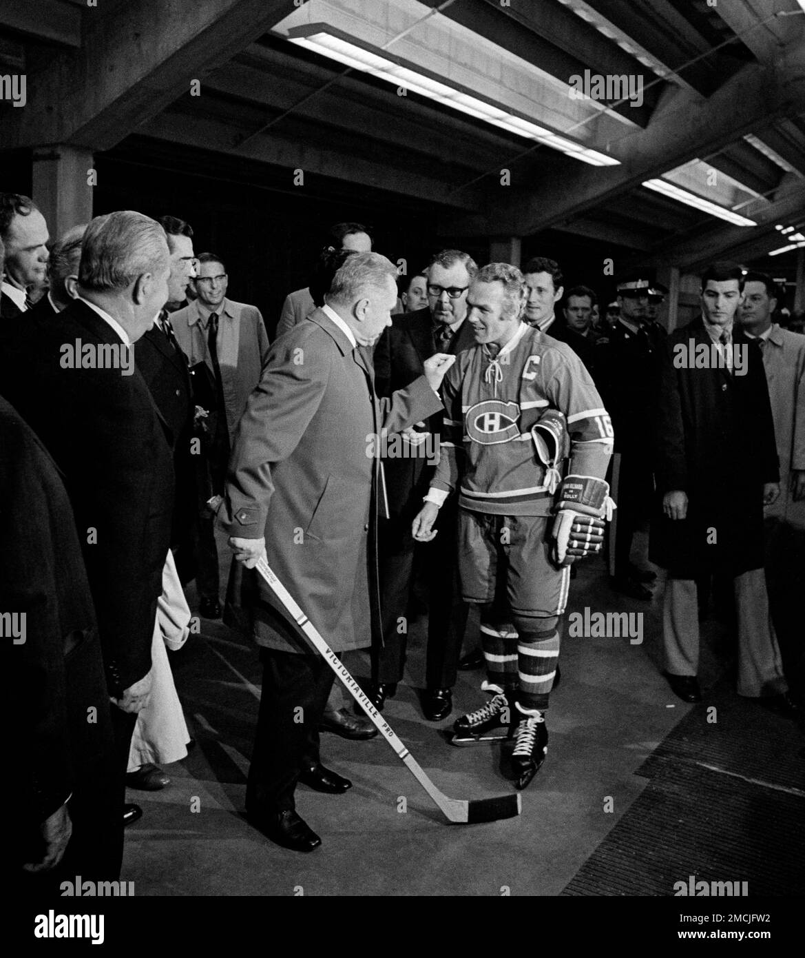 With a hockey stick in one hand, Soviet Premier Alexei Kosygin talks ...