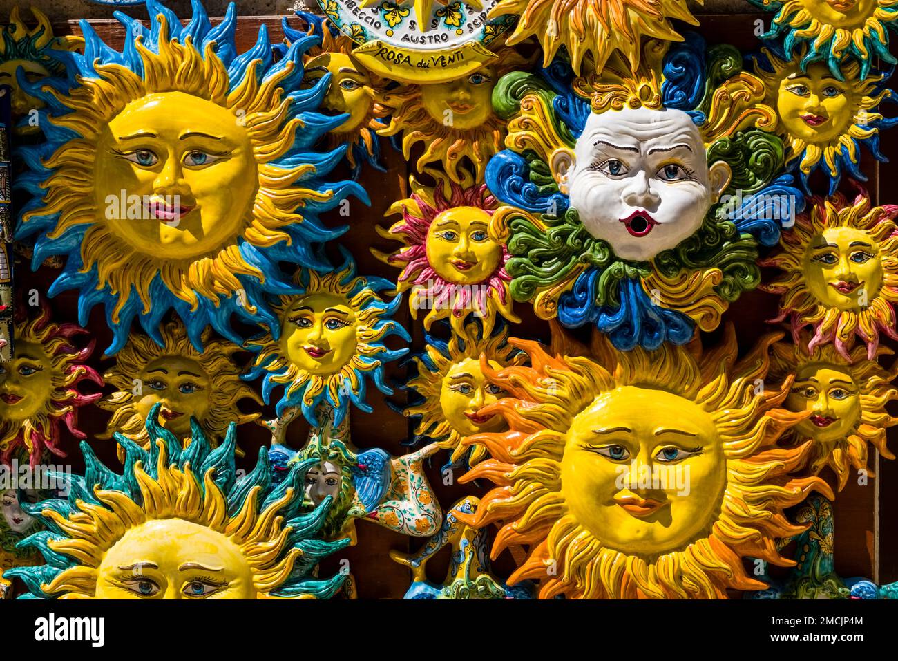 Colorfully painted terracotta sun symbols are for sale in the souvenir ...