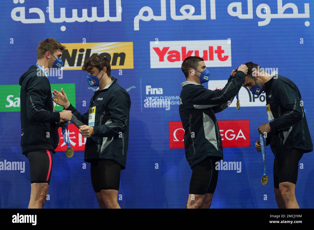 Team Italy stands on the podium after winning the 4x100 medley relay ...