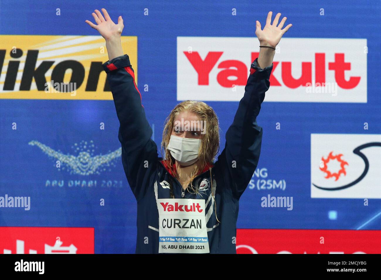 Claire Curzan of the United States stands on the podium after winning ...