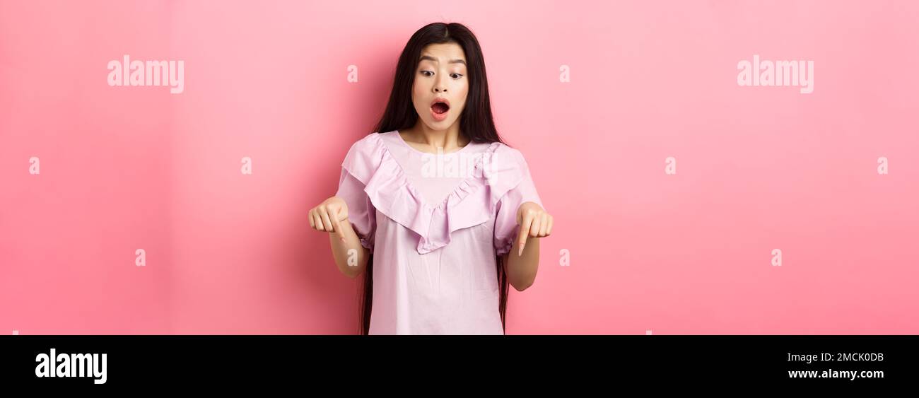 Surprised Asian Woman In Awe Drop Jaw And Gasping Pointing Fingers