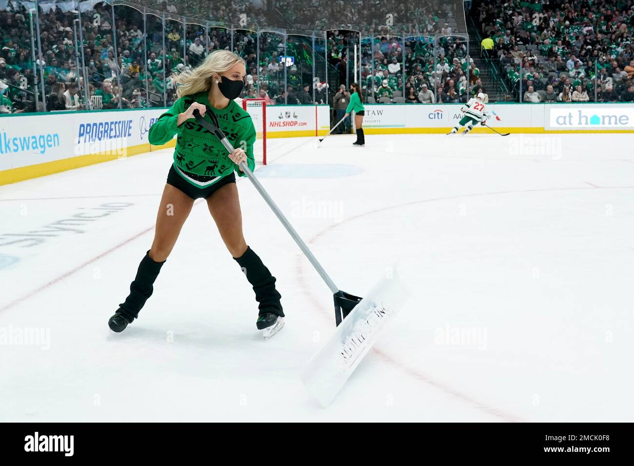 The Dallas Stars Ice Girls clear frost off the rink during an NHL ...