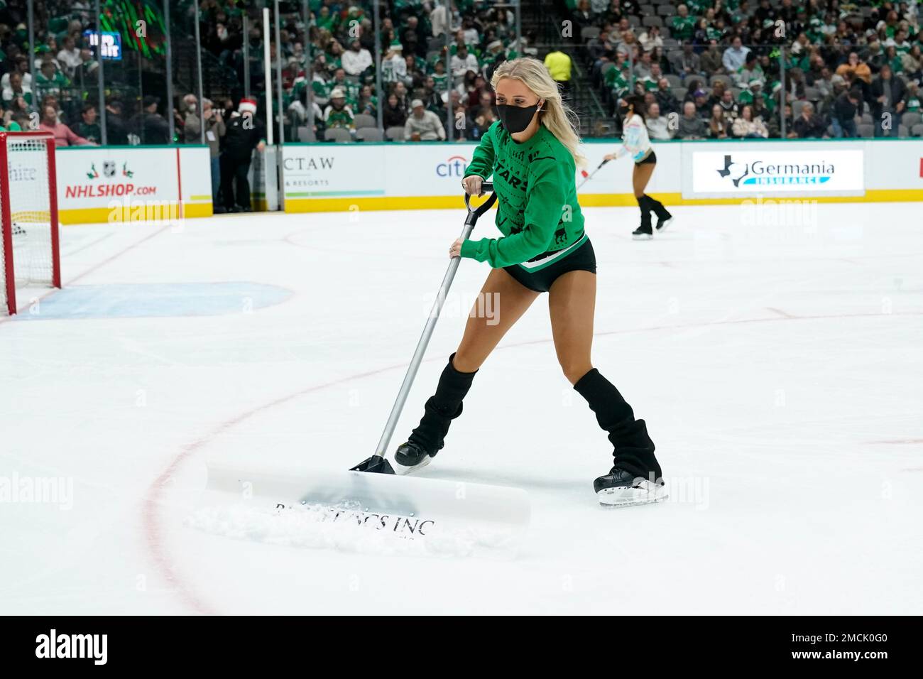 The Dallas Stars Ice Girls clear frost off the rink during an NHL ...
