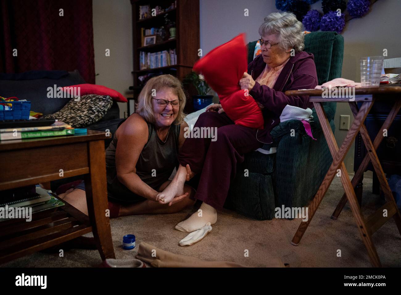 Susan Ryder, 54, giggles as she applies an ointment to the base of her ...
