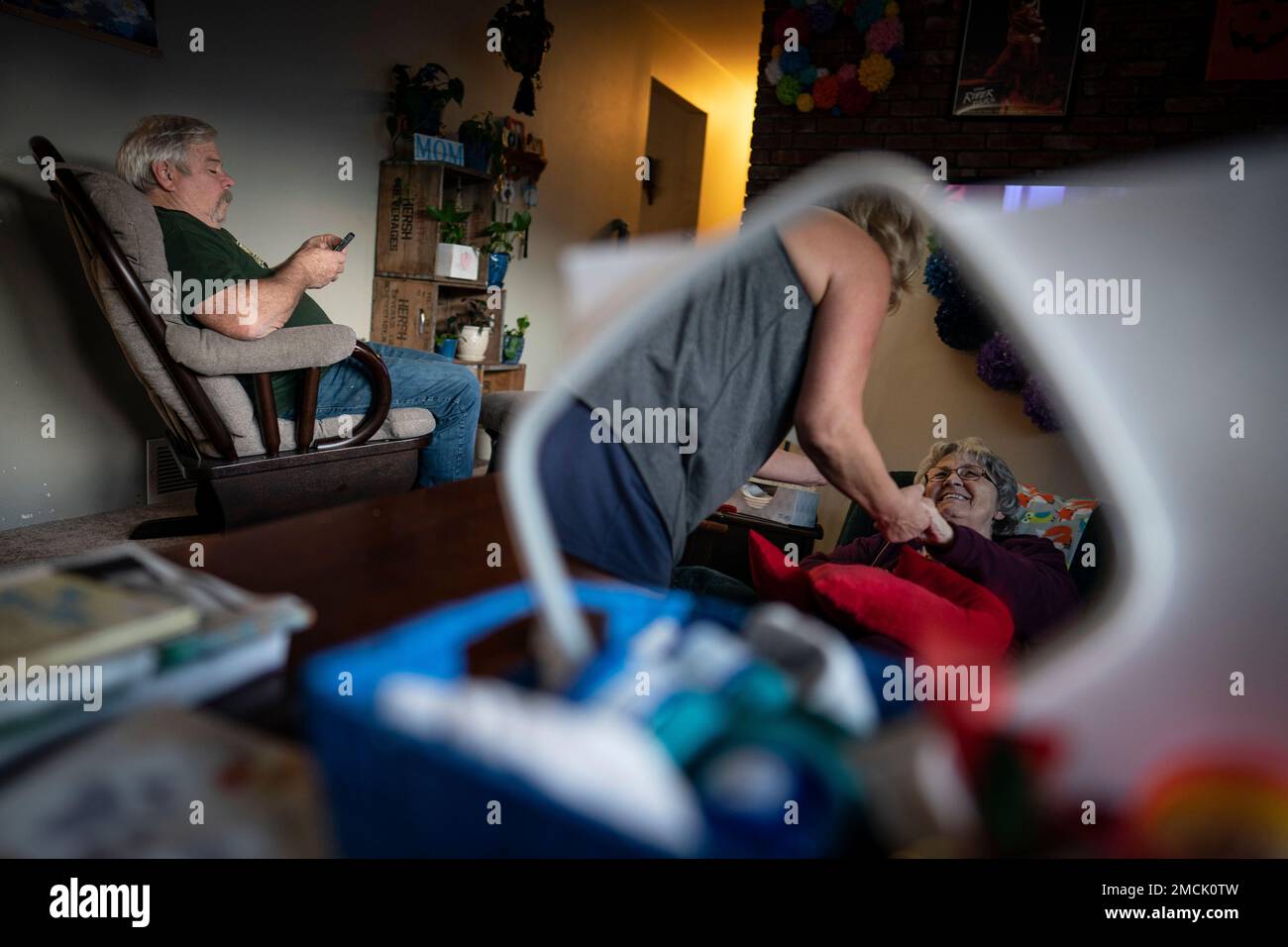 Jimmy Ryder rests, as his wife, Susan Ryder, dances with her mother ...