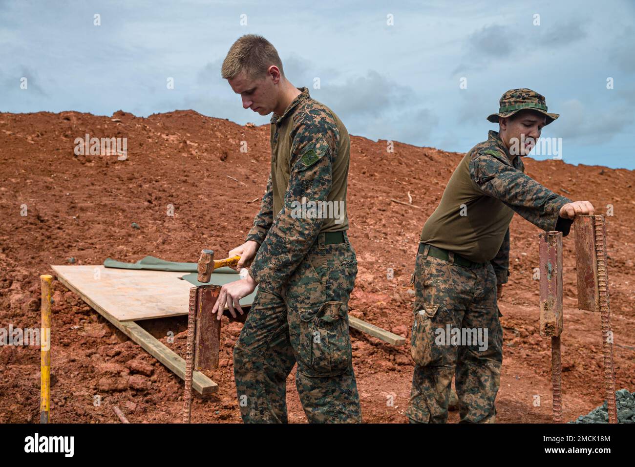 U.S. Marine Corps Lance Cpl. Shane Cooke, left, an engineer equipment ...