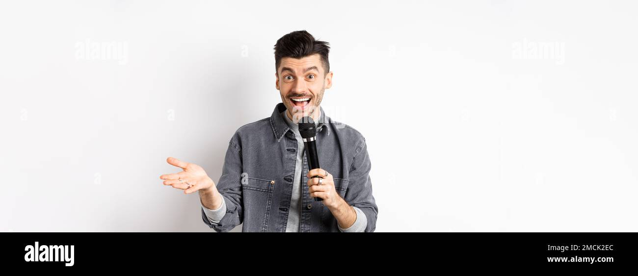 Handsome smiling performer talking in mic, gesturing and performing ...