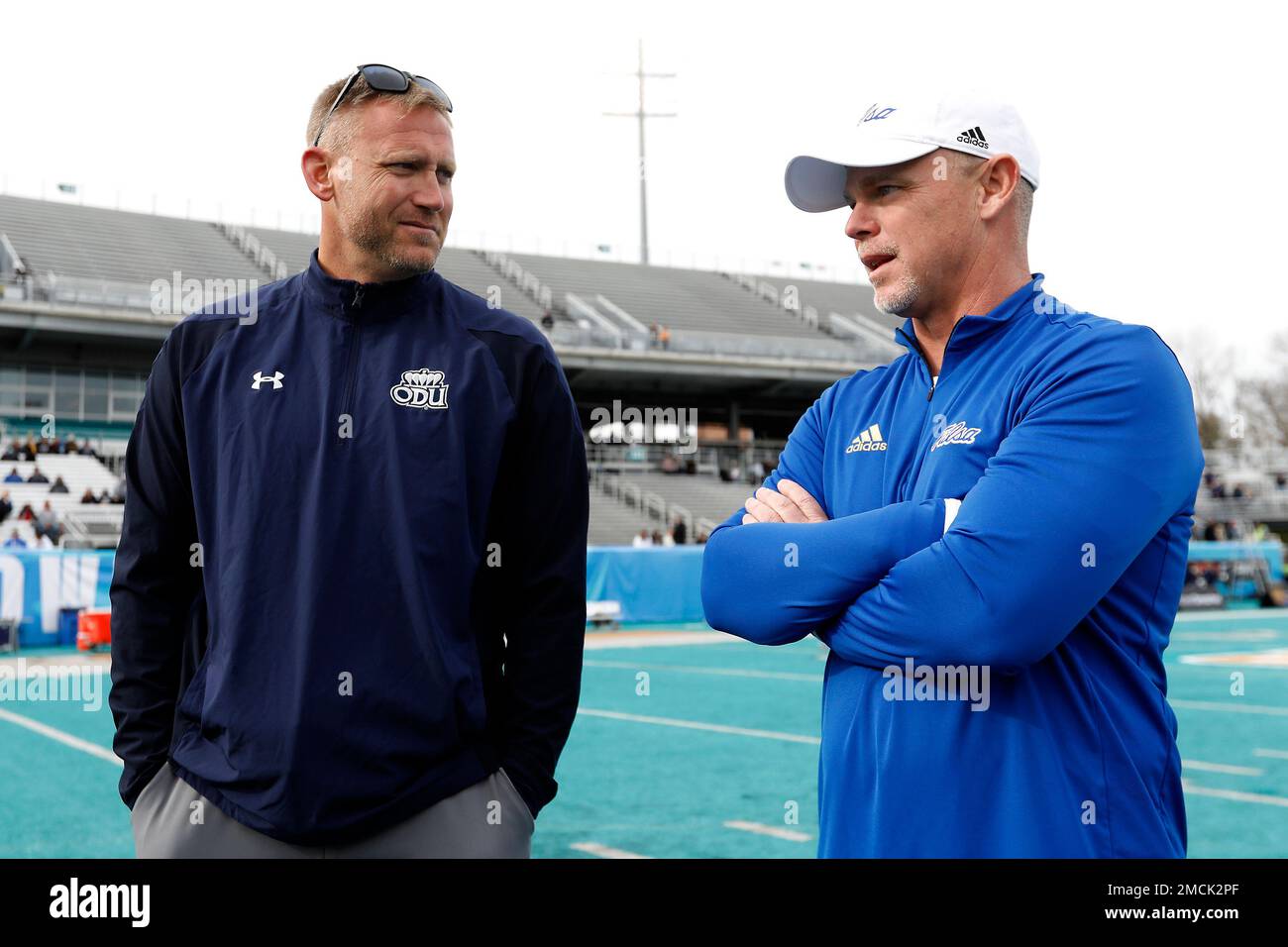 Old Dominion head coach Ricky Rahne, left, talks to Tulsa head coach ...