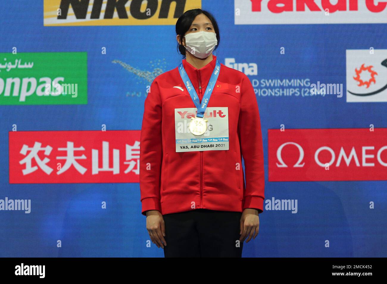 China's Qianting Tang stands on the podium after winning the 100 meters ...