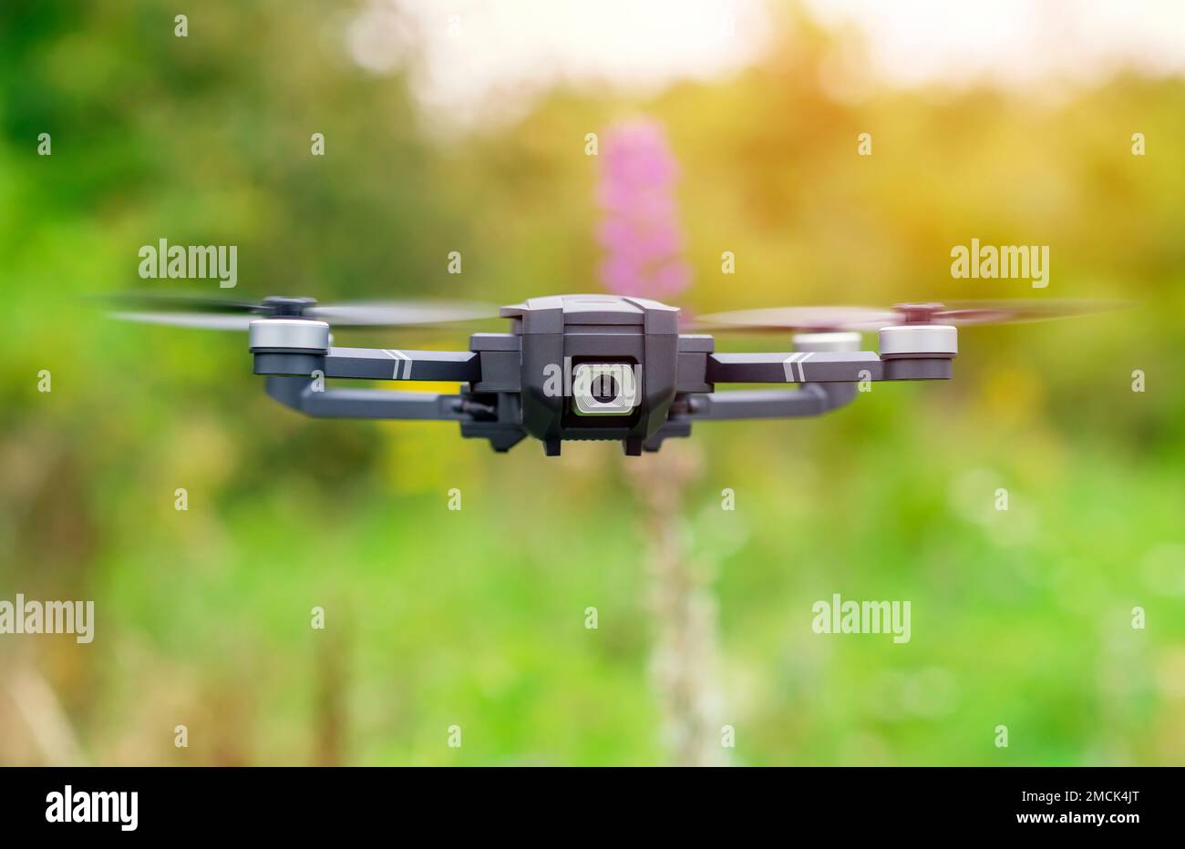 man using a drone with remote controller making photos and videos ...