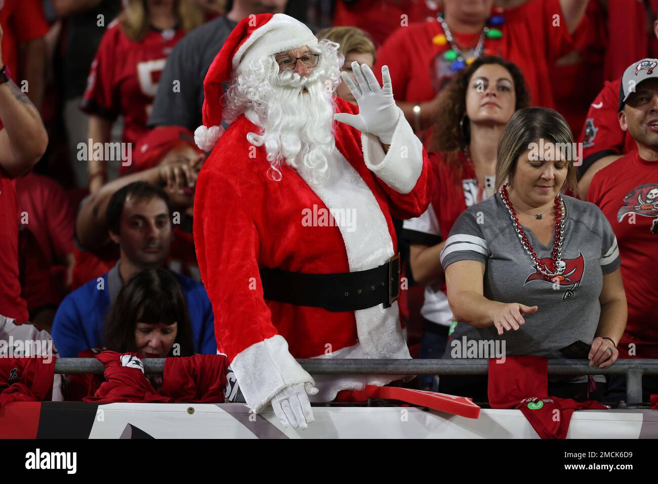 A fan is dressed as Santa Claus during the first half of an NFL ...
