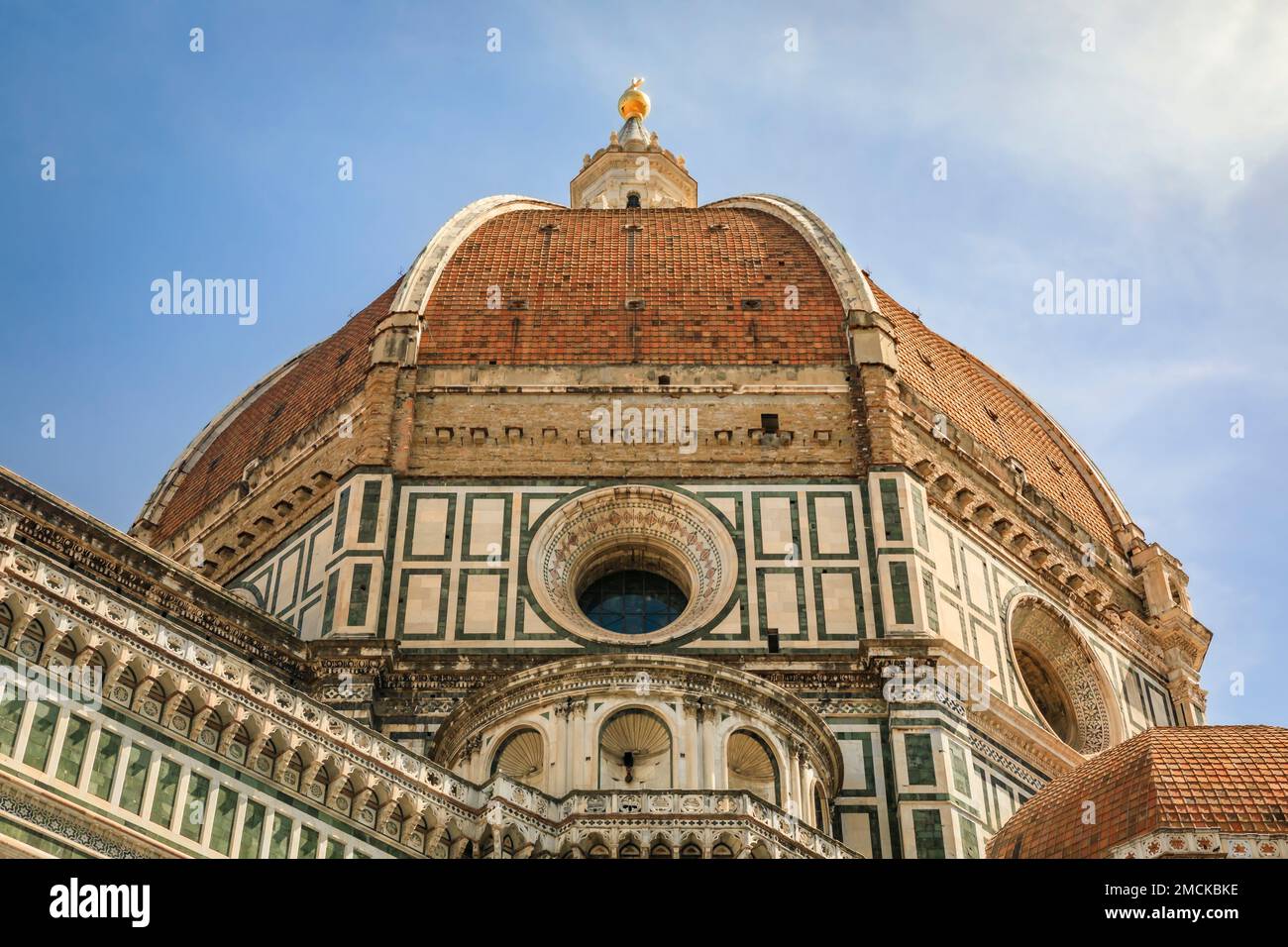 Ornate colorful marble facade and the red tiled Brunelleschi dome of ...