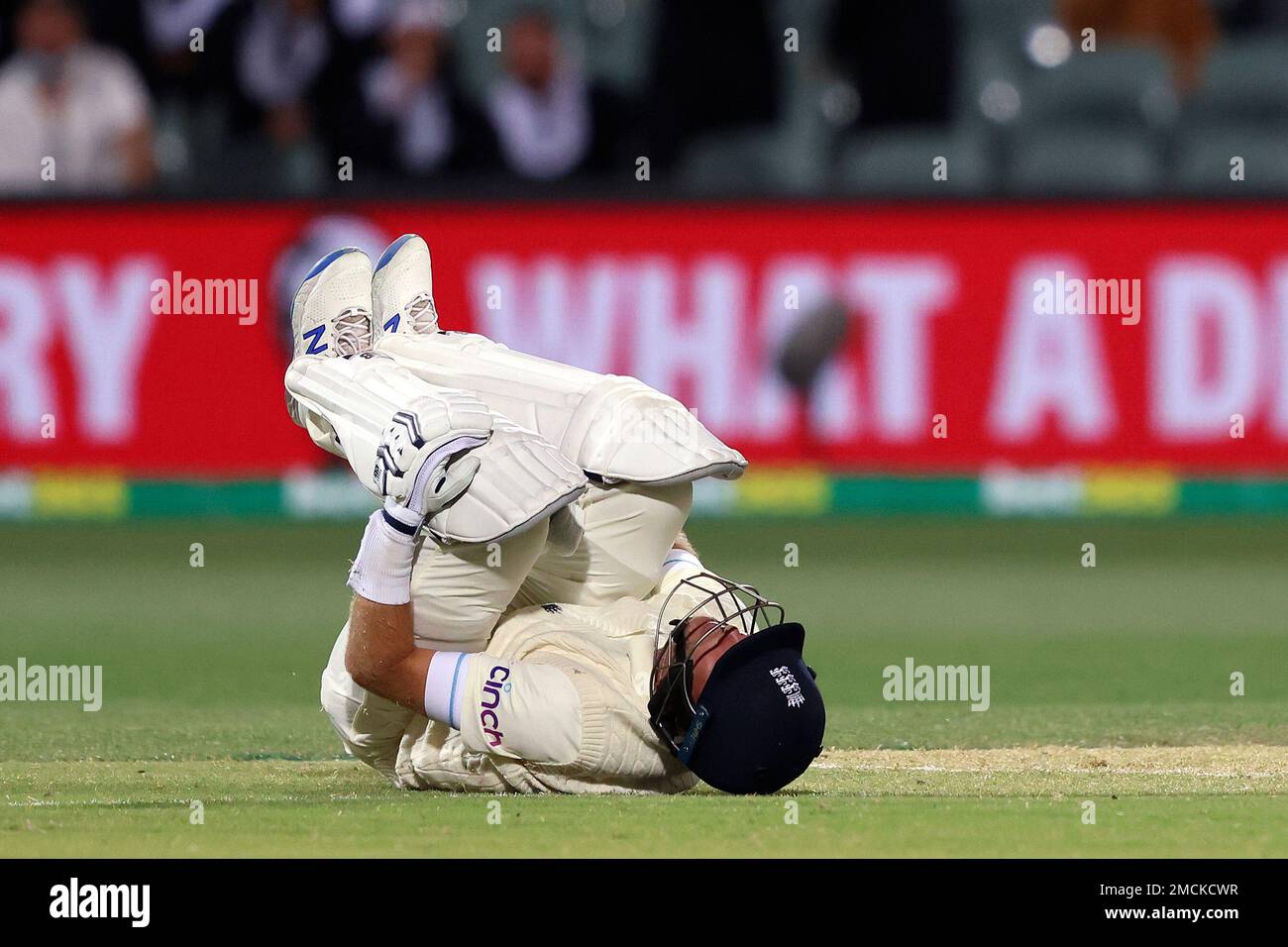 England's Joe Root falls to the ground after he is struck by a delivery ...