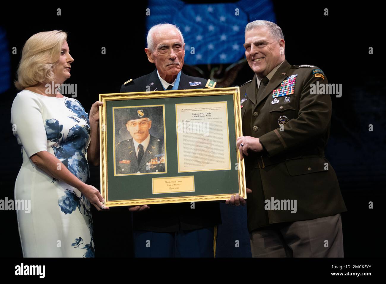 Secretary of the Army Christine Wormuth presents a photo and citation ...
