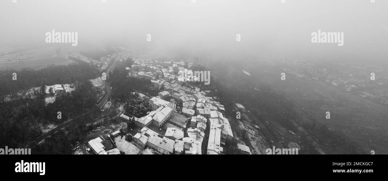 Aerial shot of winter landscape near italian apennines town covered in ...