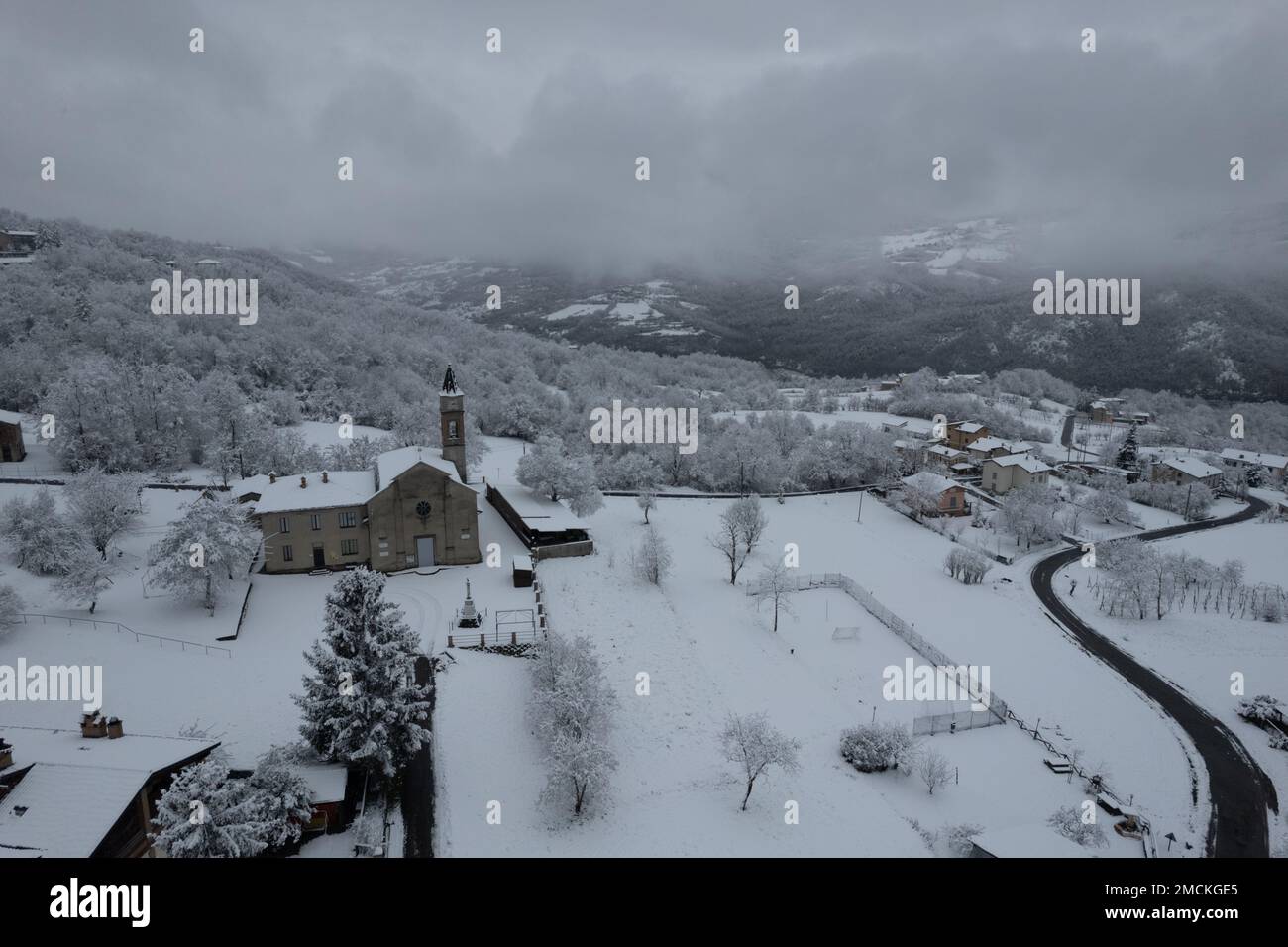 Aerial shot of winter landscape near italian apennines town covered in ...