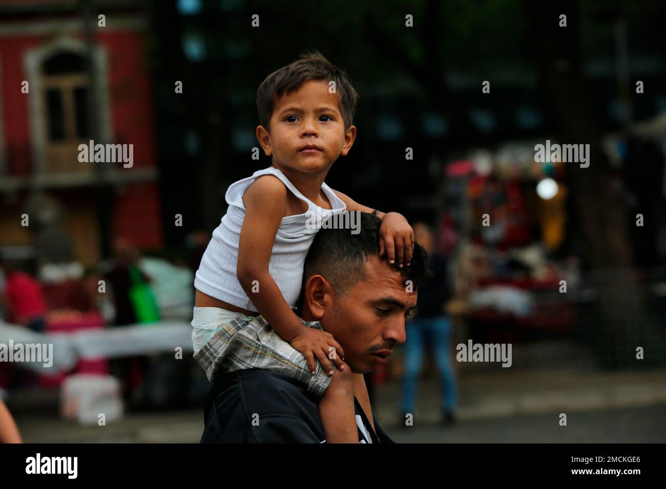 Honduras migrant Kevin Bonilla, 27, carries his son Cristian, 2, on his ...