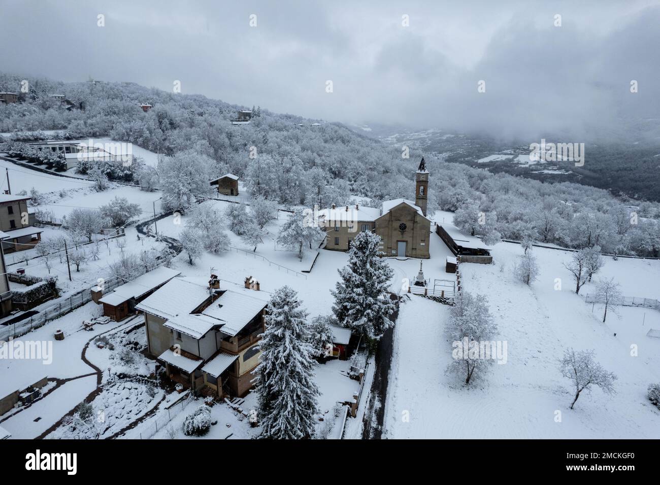 Aerial shot of winter landscape near italian apennines town covered in ...