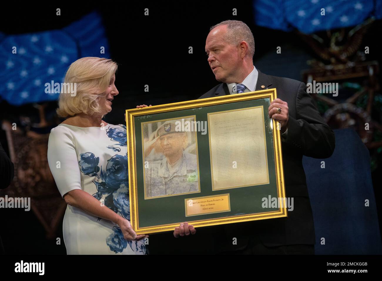 Secretary of the Army Christine Wormuth presents a photo and citation ...