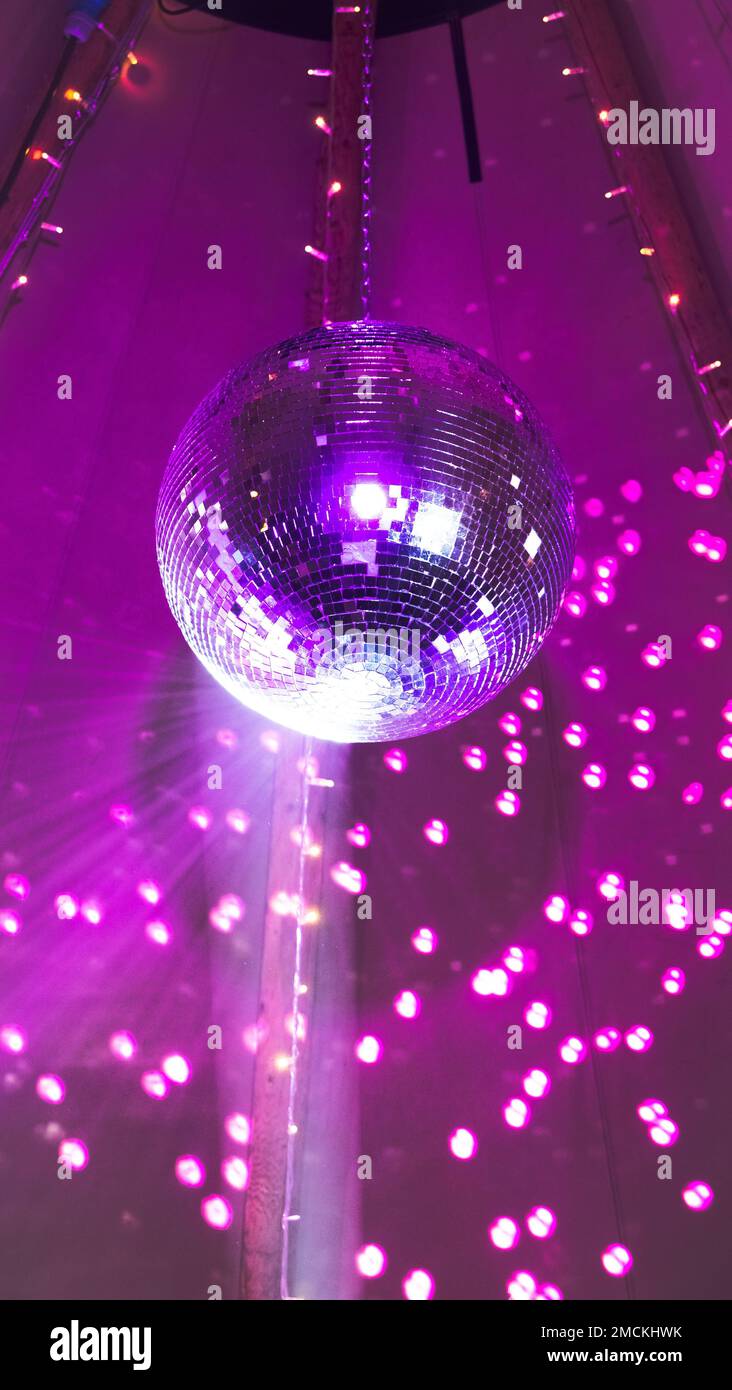 A vertical shot of a purple disco ball in a hall Stock Photo - Alamy