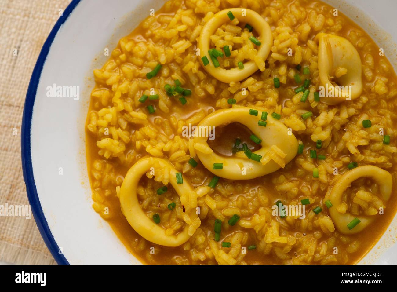 Original spanish paella recipe with squid and vegetables Stock Photo ...