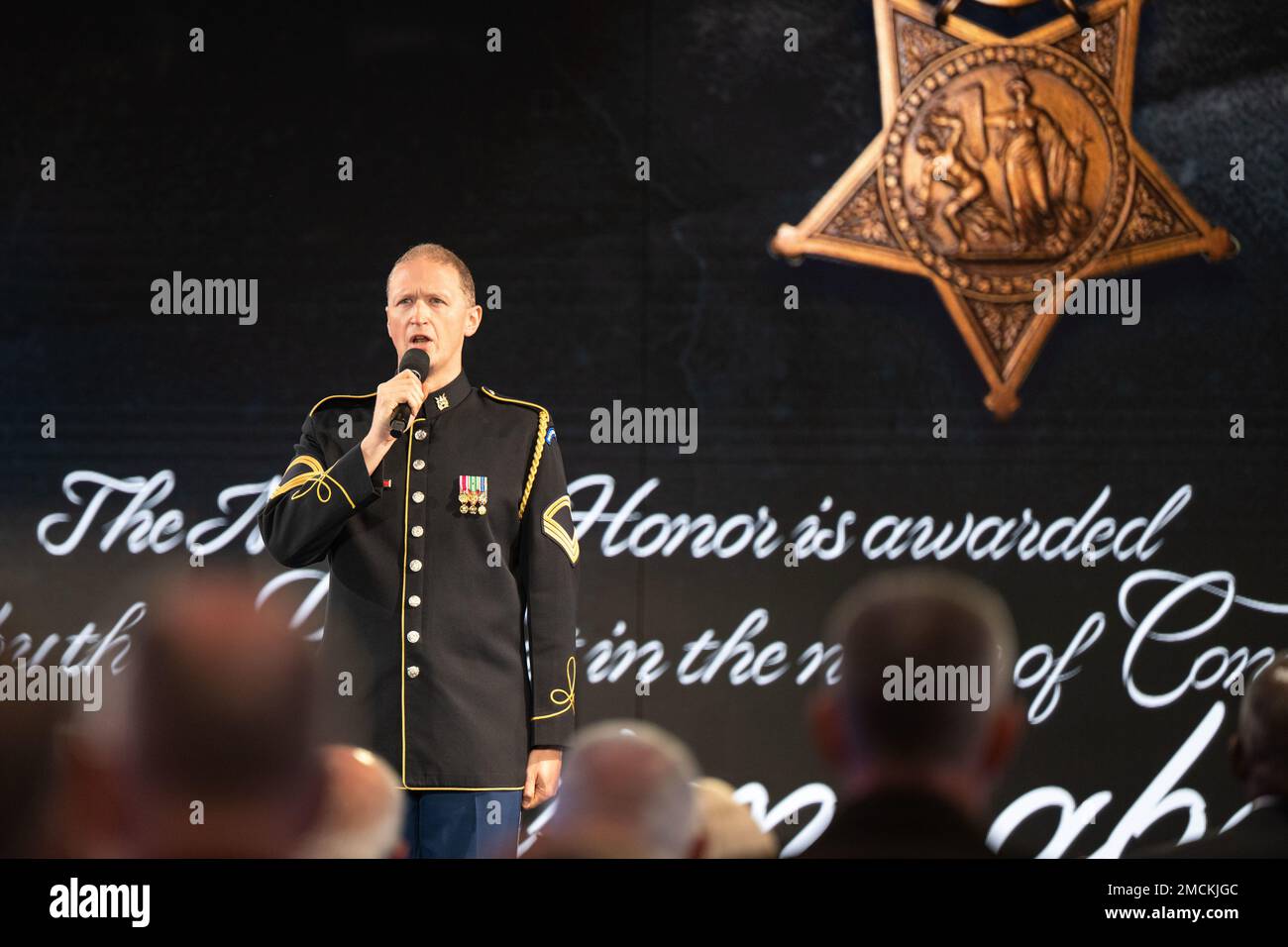 Sgt. 1st Class Brendan Curran sings the National Anthem during a ...