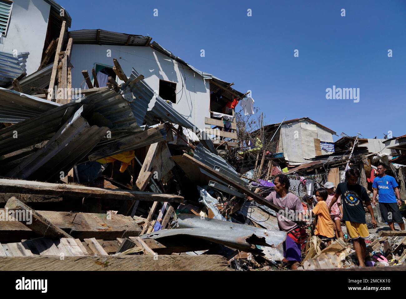 Residents salvage parts of their homes damaged due to Typhoon Rai in ...