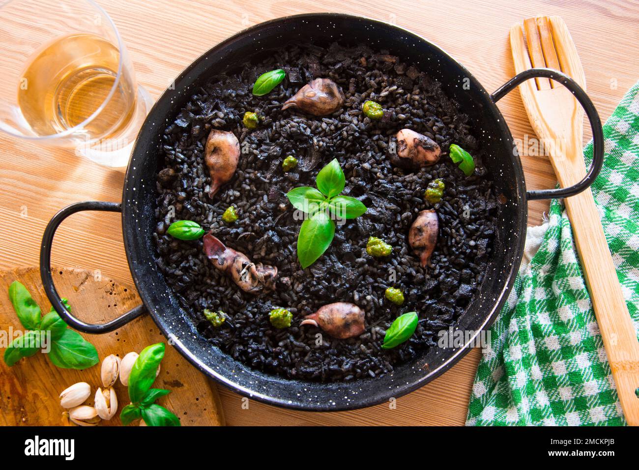 Original spanish black paella recipe with seafood Stock Photo - Alamy