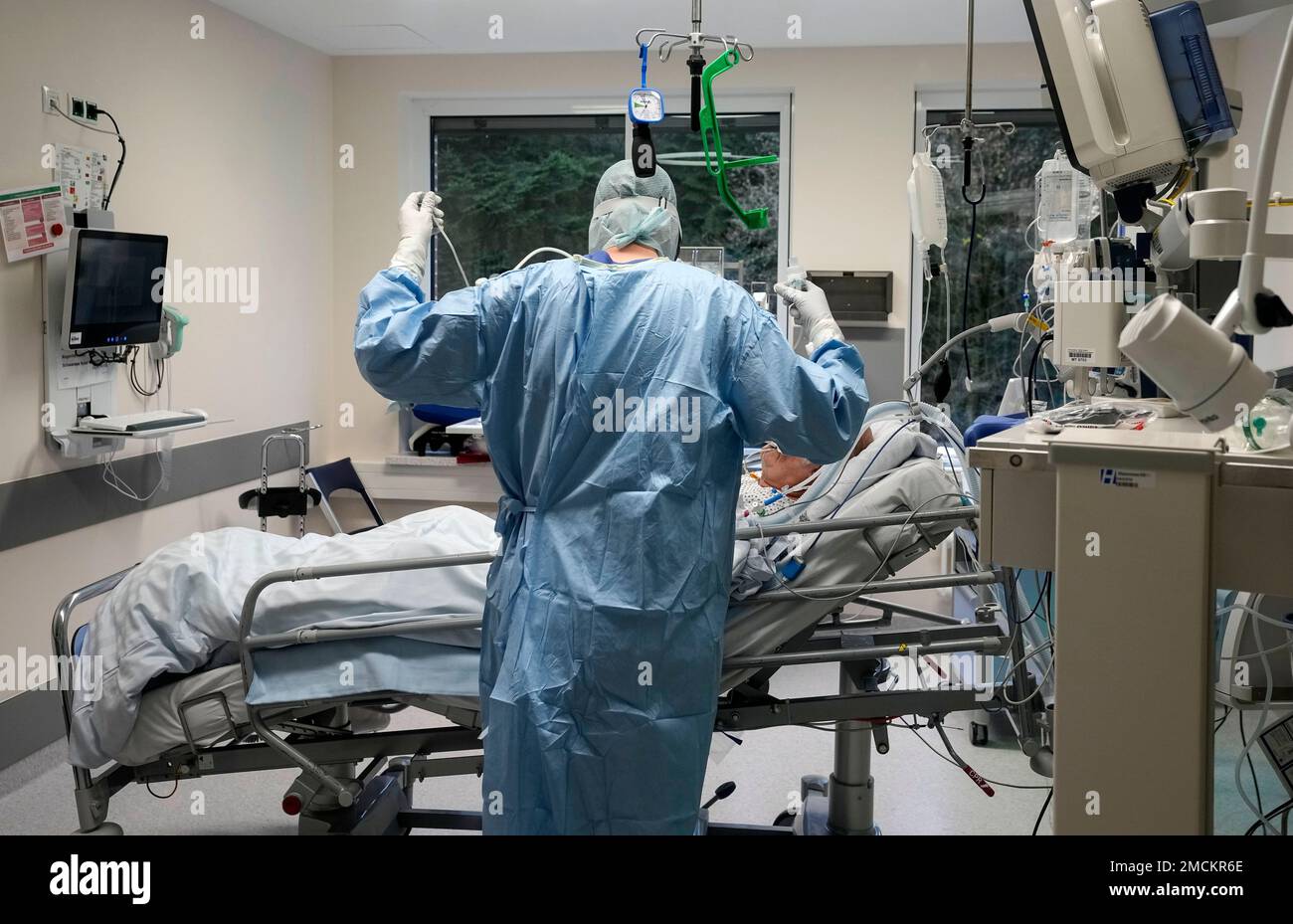 An intubated COVID-19 patient gets treatment at the intensive care unit ...