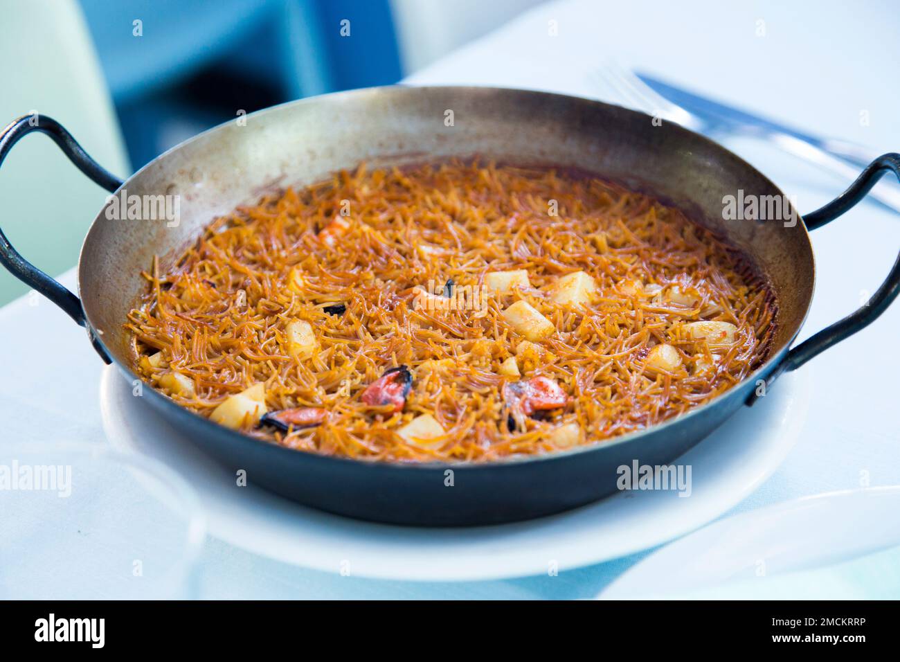 Original spanish fieua paella recipe with seafood Stock Photo - Alamy