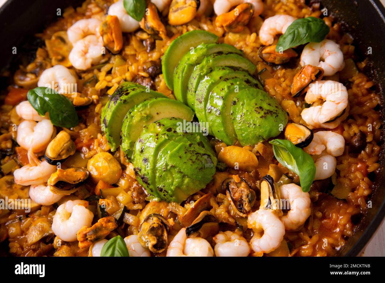 Seafood paella with shrimps and avocado. Authentic Paella spanish ...