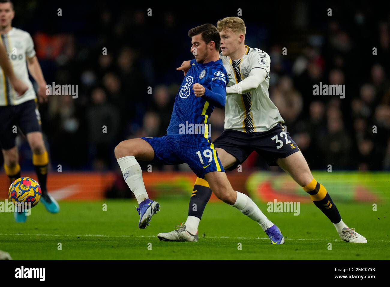 Chelsea's Mason Mount, left, challenges for the ball with Everton's ...