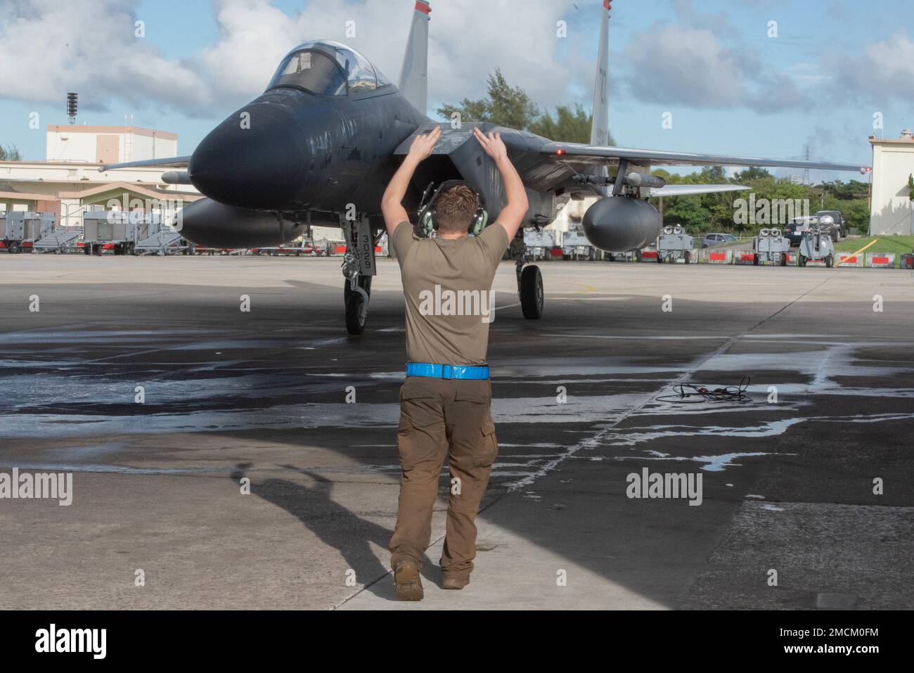 Airman 1st Class Trevor Finley, 44th Aircraft Maintenance Unit crew chief, marshals an F-15C ...