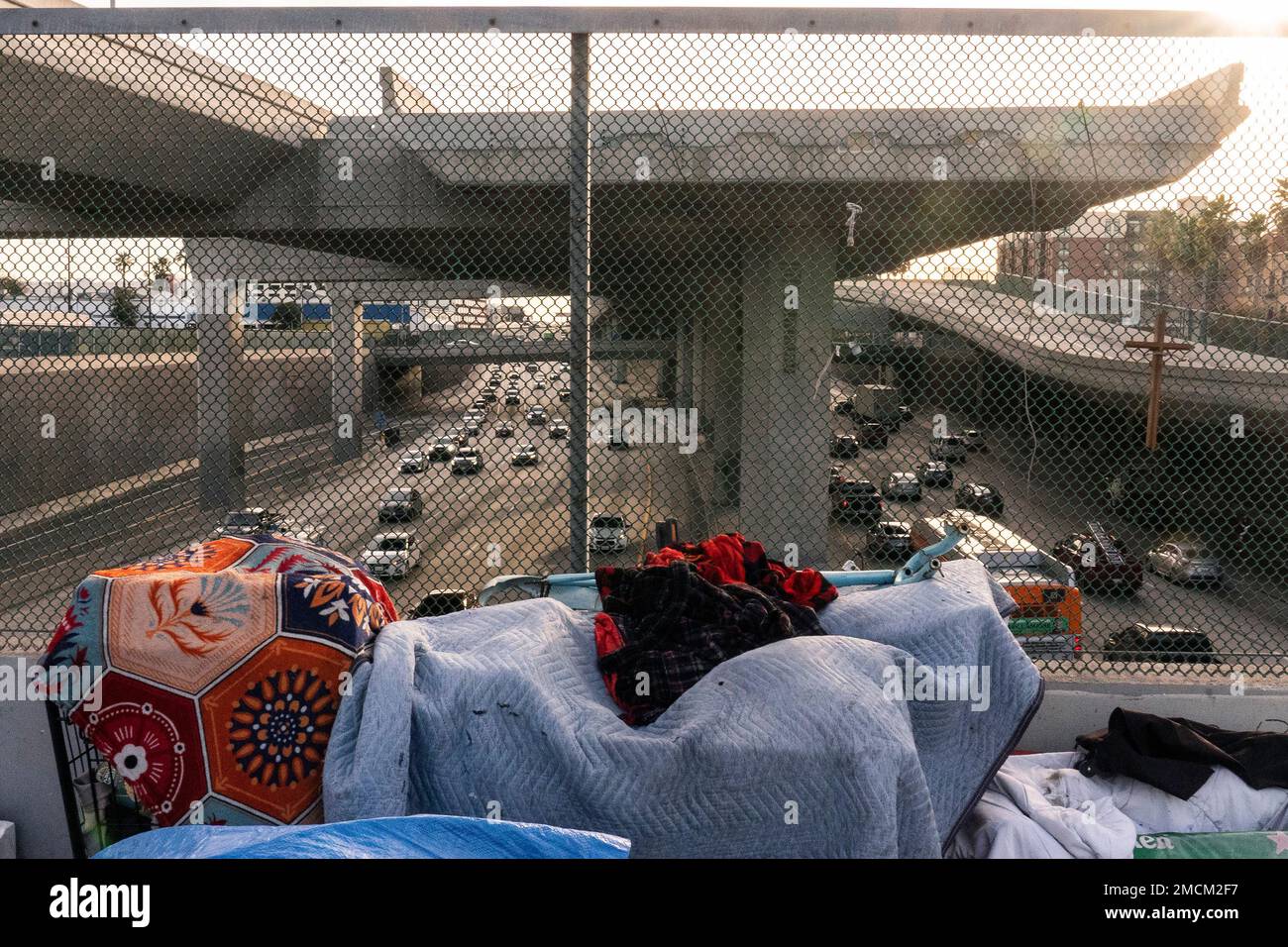 A homeless encampment is seen on a bridge over the CA-110 freeway ...