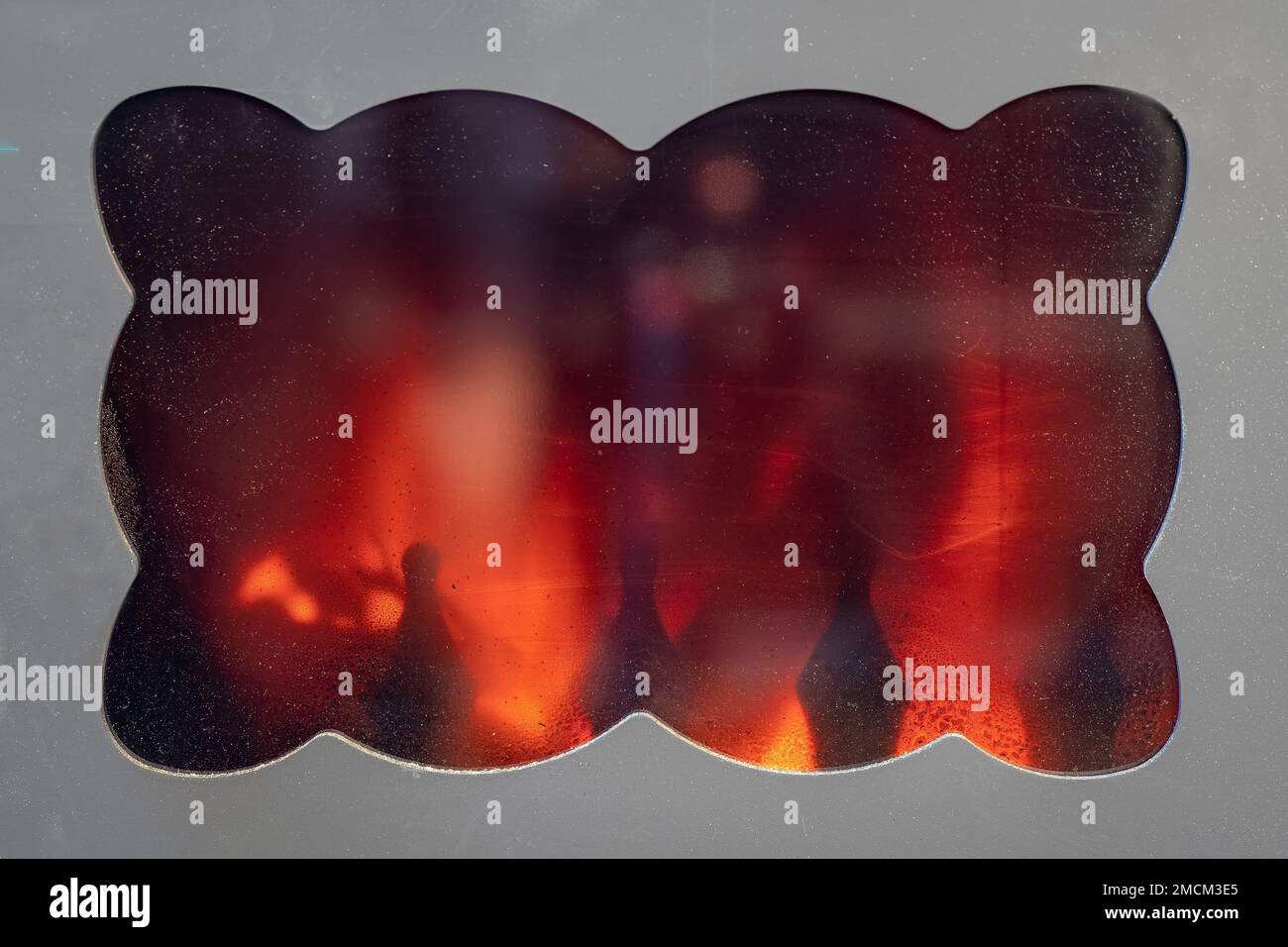 Rustic cast iron stove window where you can see the fire burning inside ...