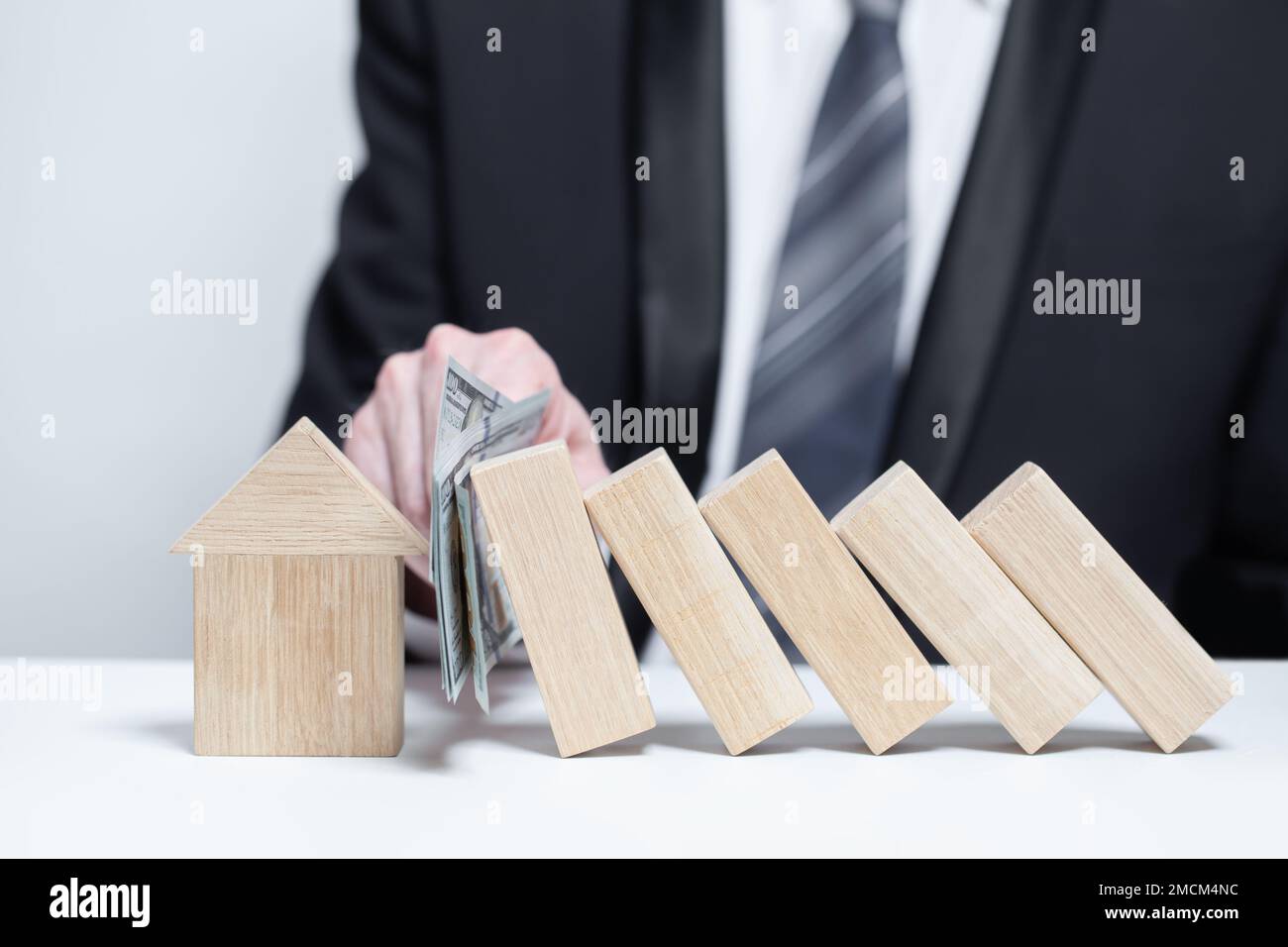 Wooden house under money protection, domino, insurance safety property ...