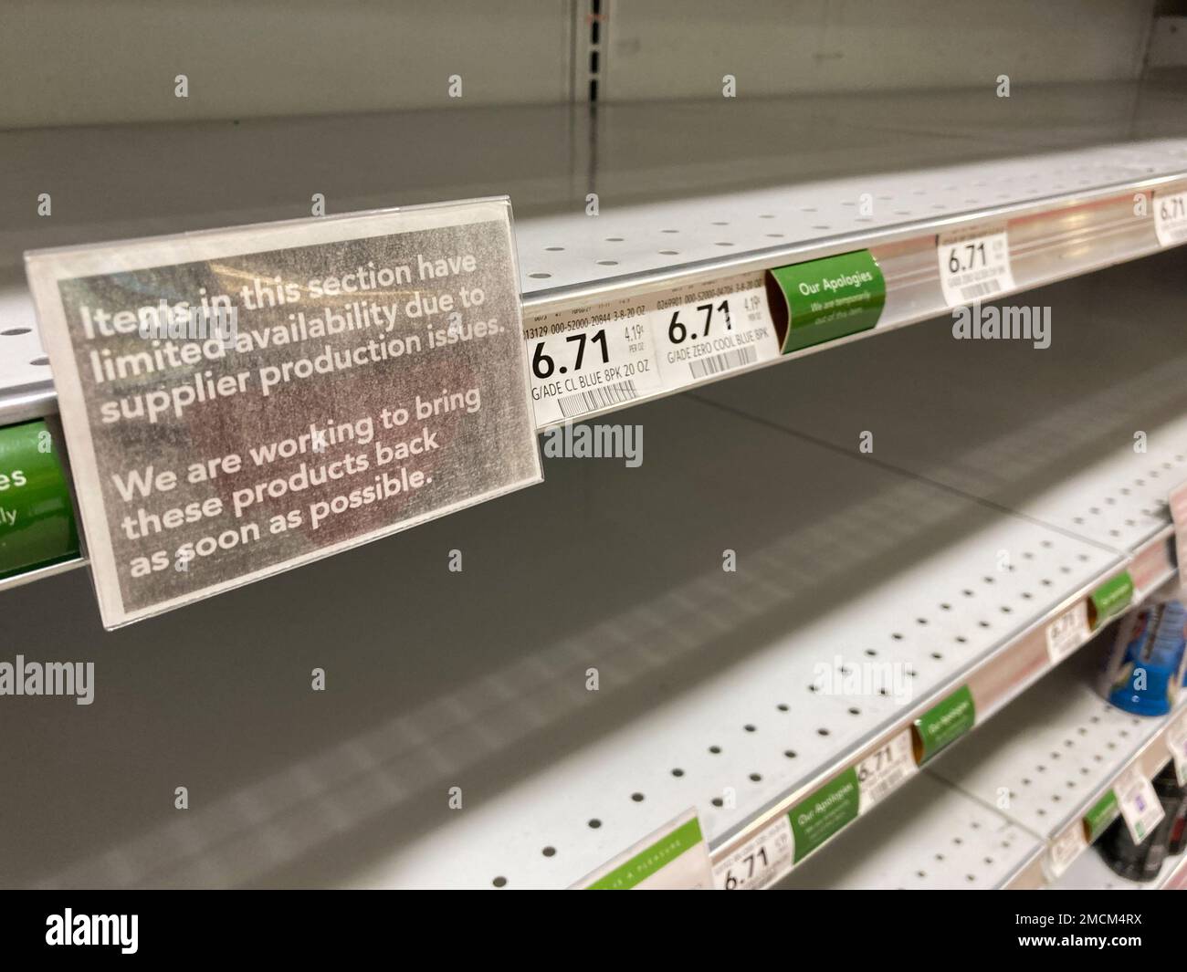 Shelves, empty "due to supplier production issues," are shown in a ...
