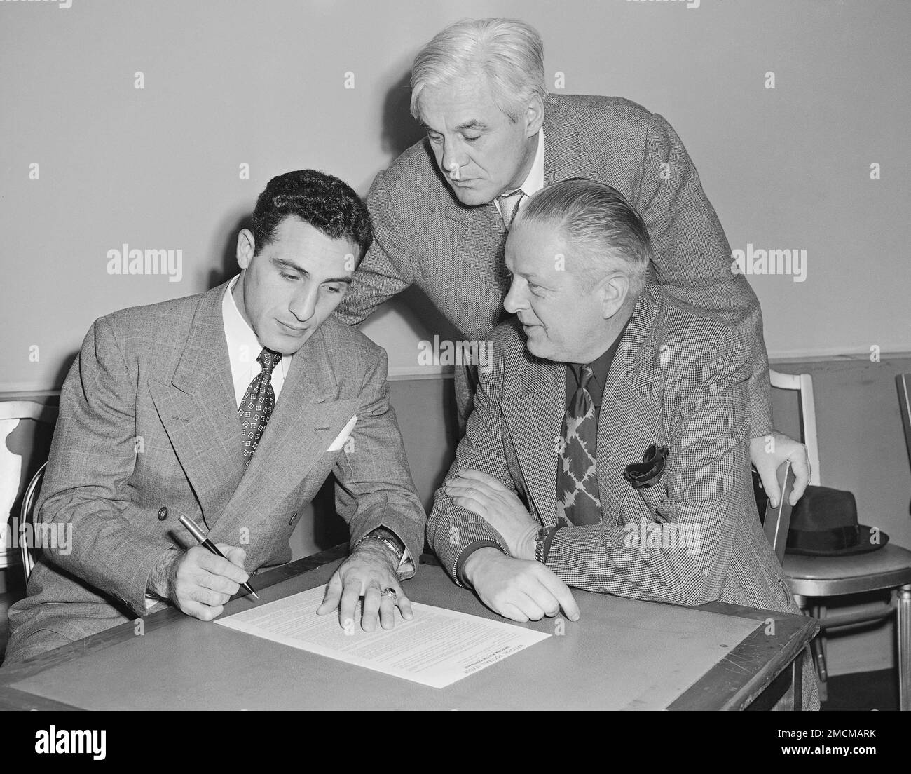 FILE - Charley Trippi, left, Georgia football star, signs his $100,000 ...
