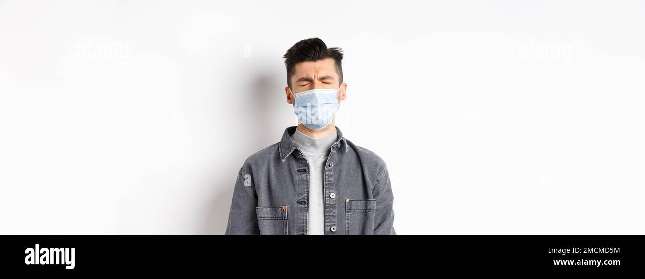 Health, covid and pandemic concept. Sad crying man in medical mask ...
