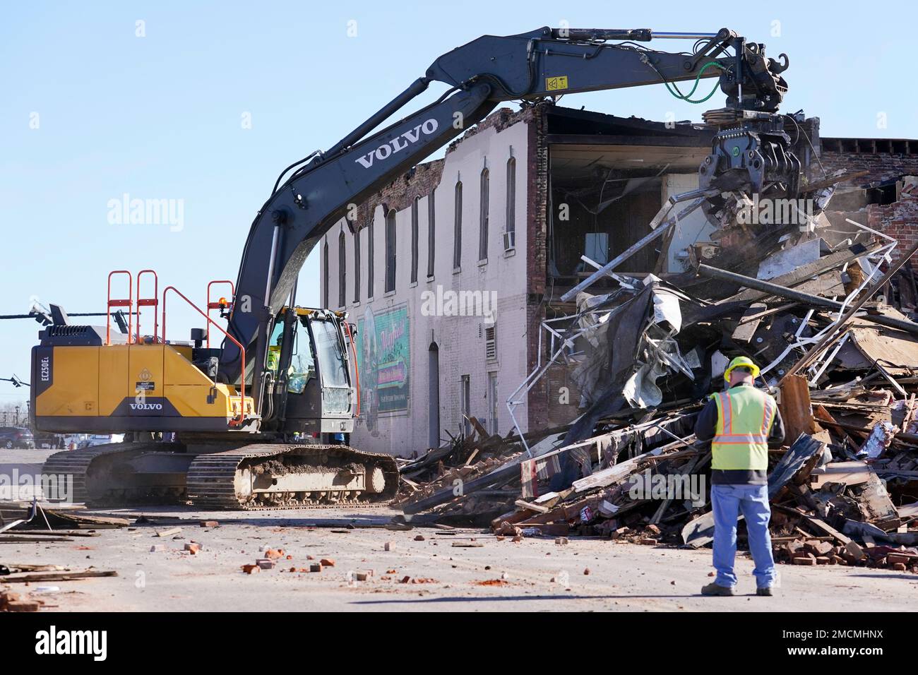 Workers remove debris from destroyed buildings Sunday, Dec. 12, 2021 ...