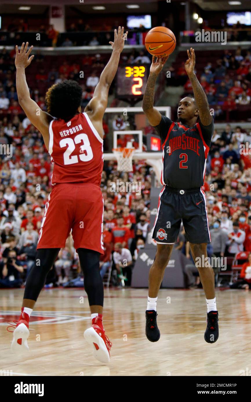 Ohio State guard Cedric Russell, right, goes up for a shot in front of ...