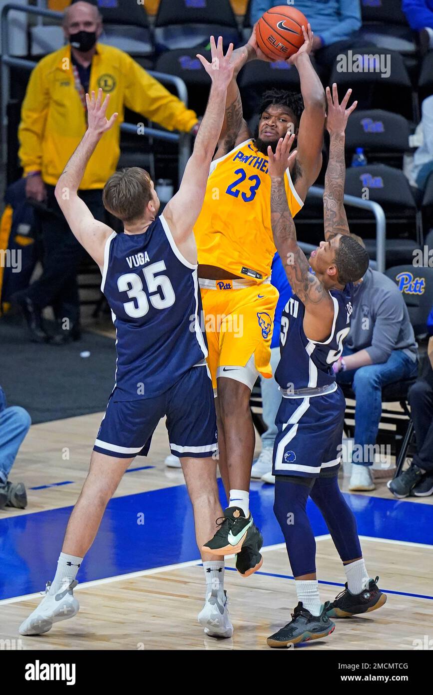 Pittsburgh forward John Hugley (23) gets off a pass between Monmouth forward Klemen Vuga (35 ...